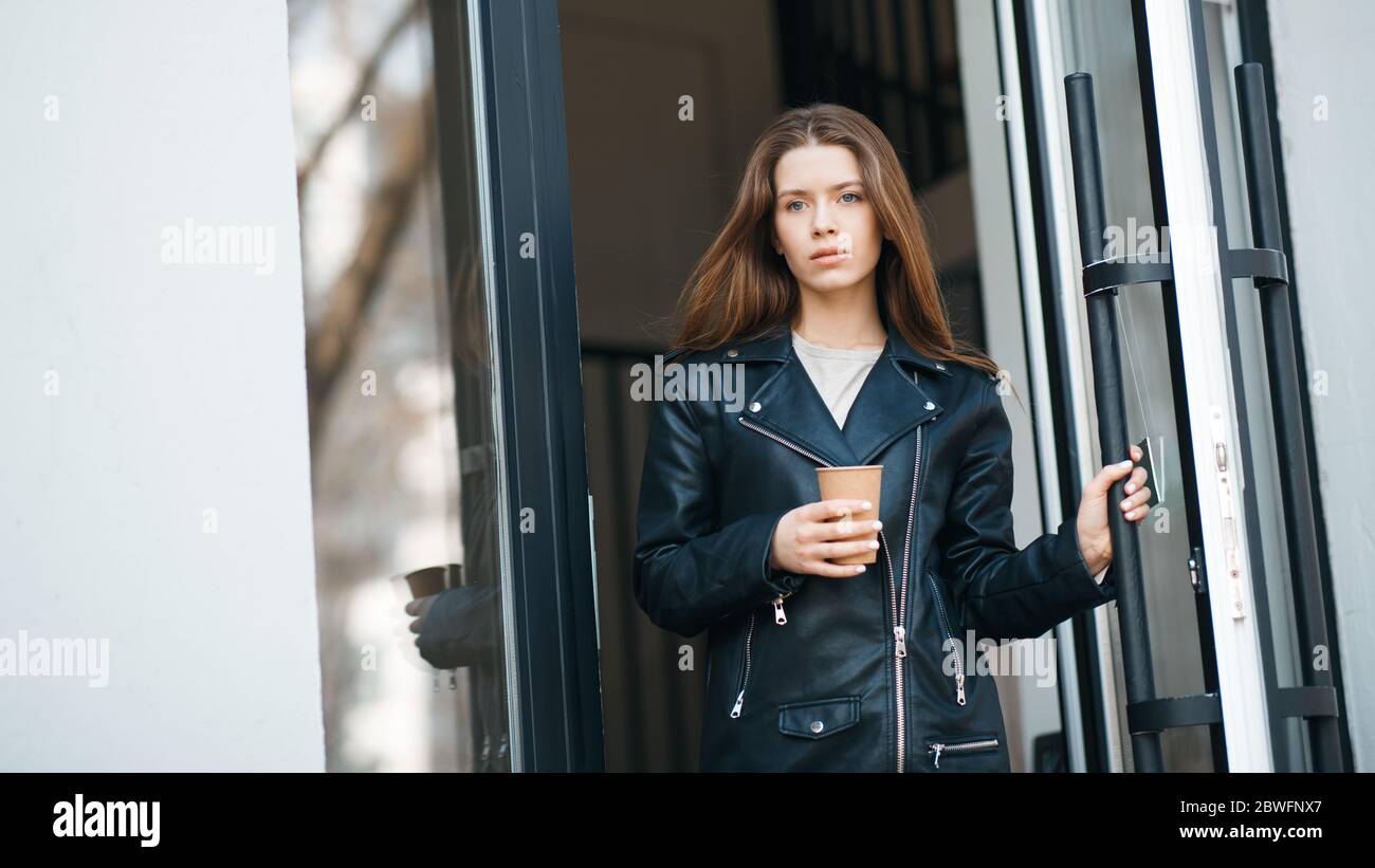 Woman walking out of door hi-res stock photography and images - Alamy