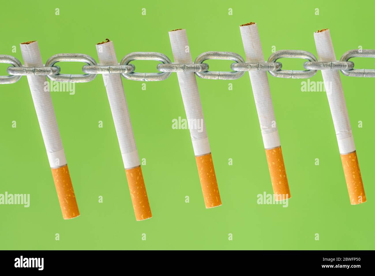 Cigarettes in a metal chain on green background, quit smoking - World ...