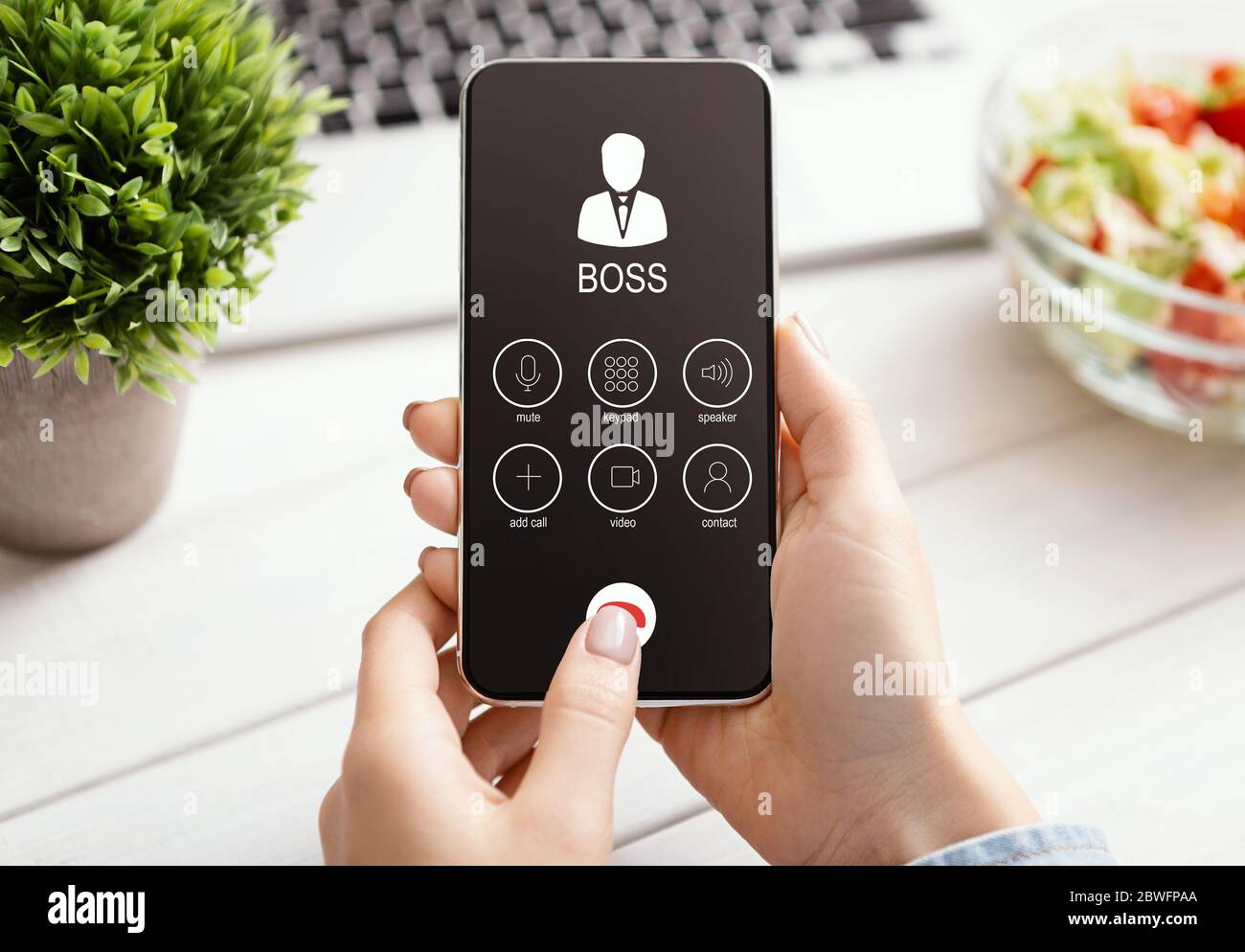 Female Hand Holding Phone With Boss Incoming Call Stock Photo - Alamy