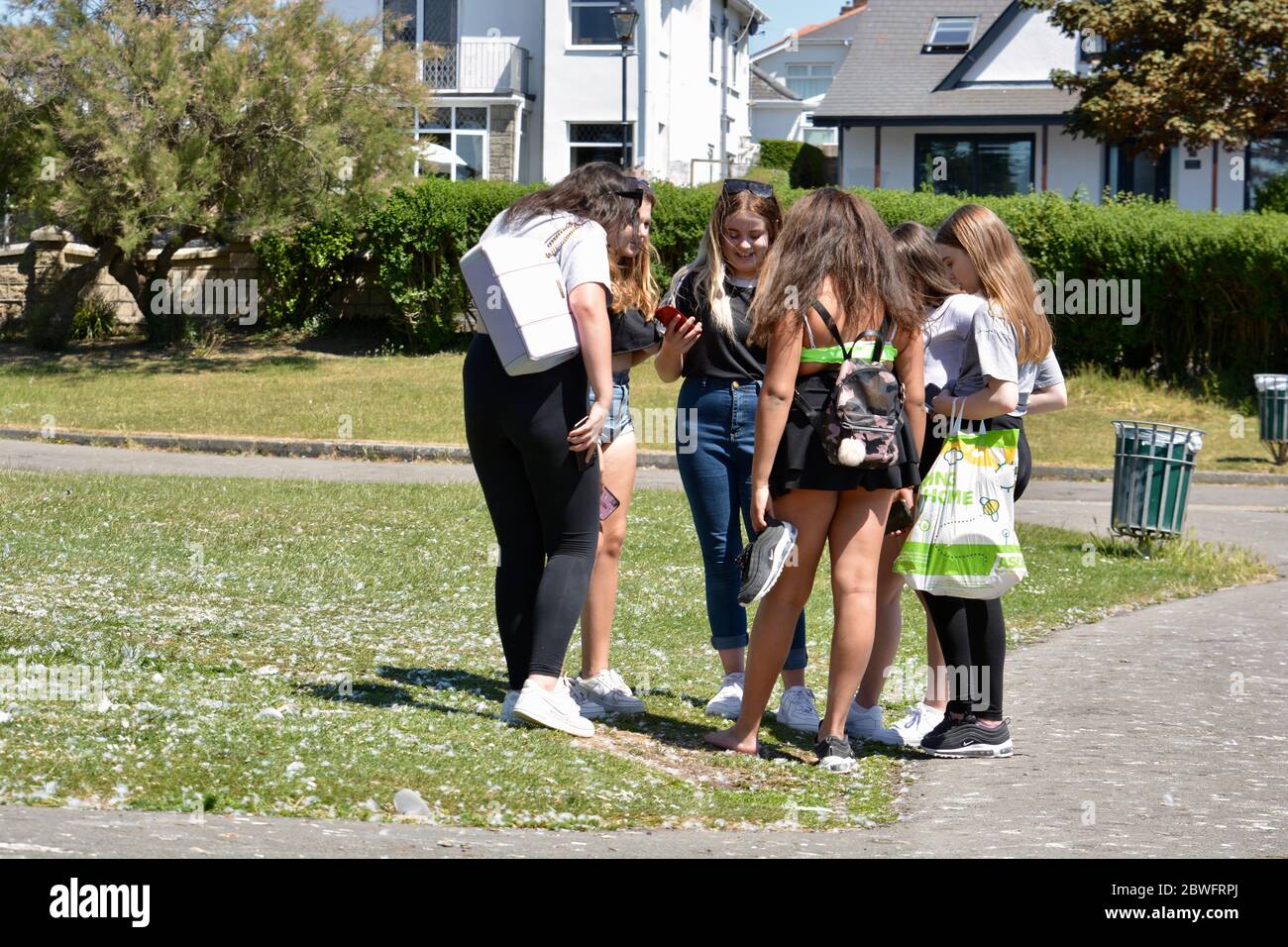 Group of young girls excited to meet up in a park after lockdown ...
