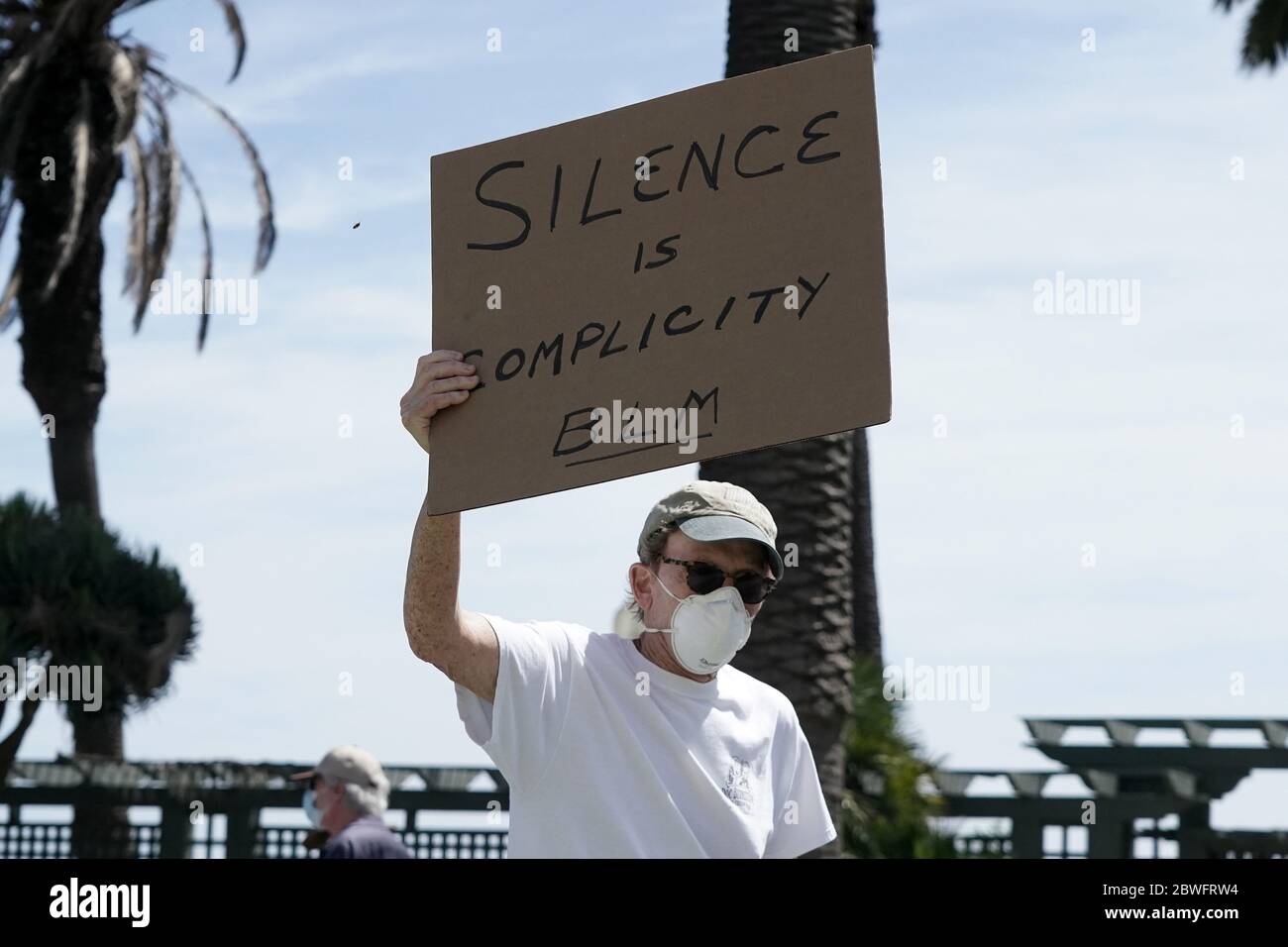 Santa Monica, United States. 31st May, 2020. A man holds a "Silence is ...