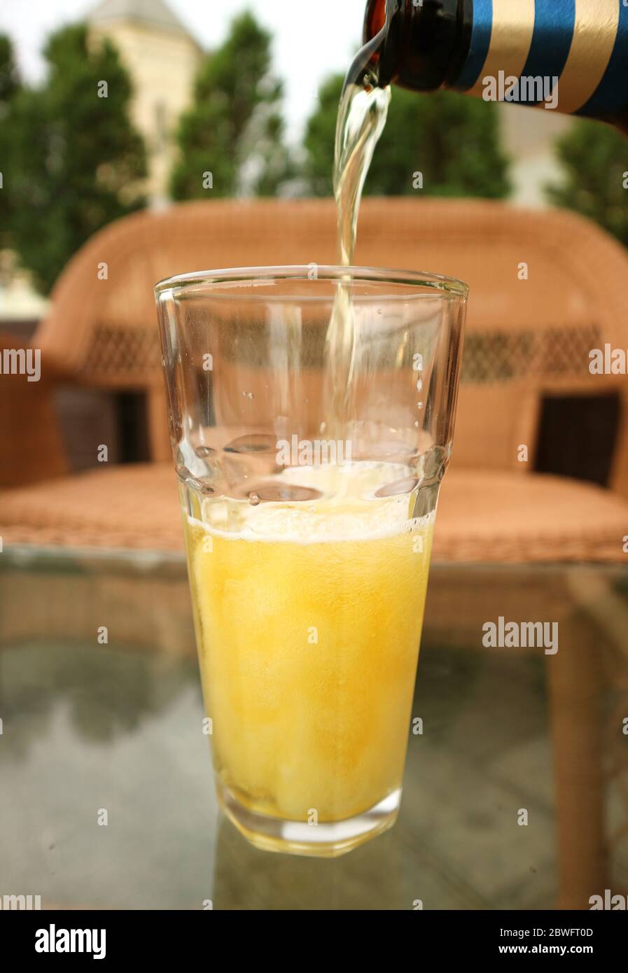 Closeup texture of chilled lager beer in a glass while being poured ...