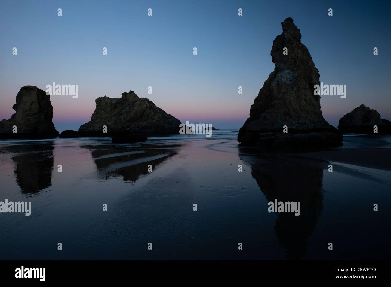 Rock formations in sea seen from Cannon Beach at sunset, Oregon, USA ...