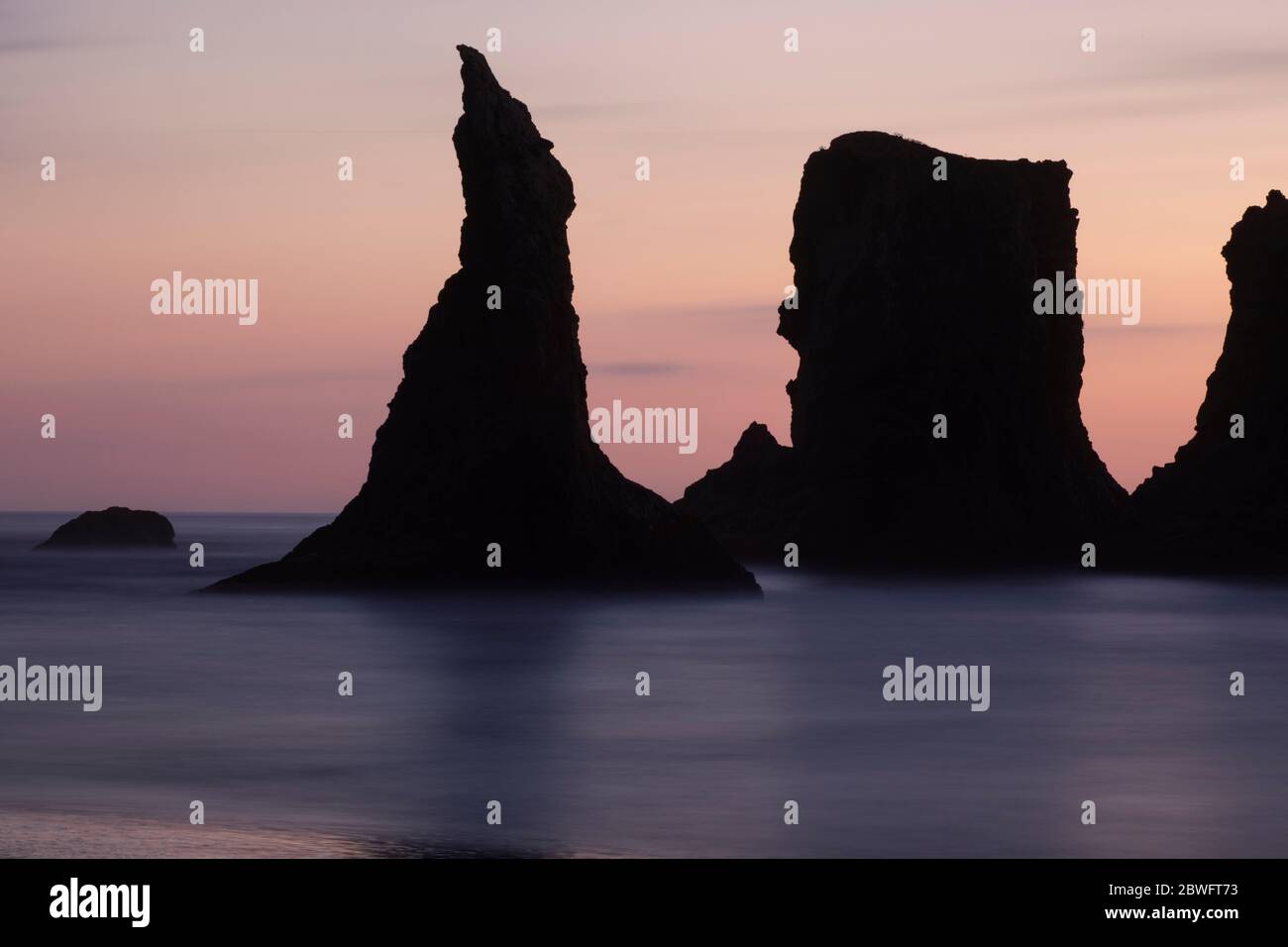 Rock formations in sea seen from Cannon Beach at sunset, Oregon, USA ...