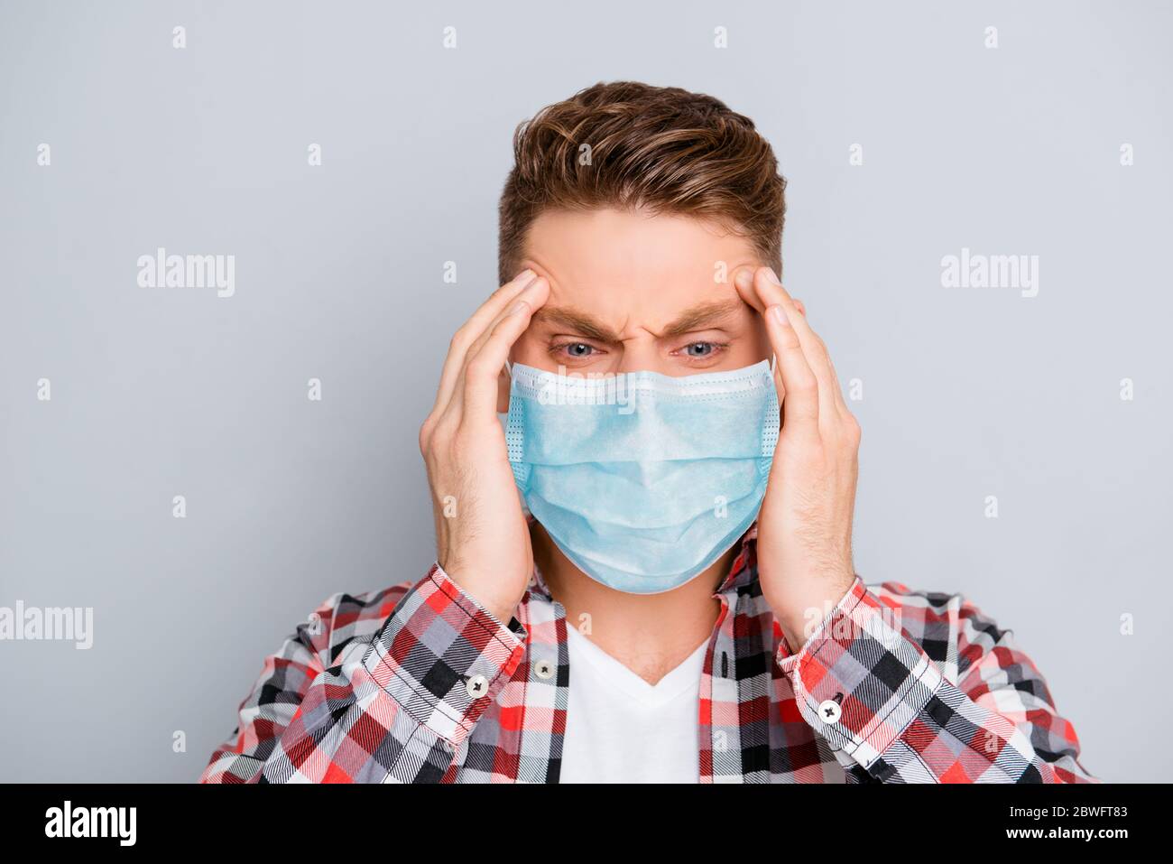Portrait of ill sick young man in shirt wear medical safety face mask ...