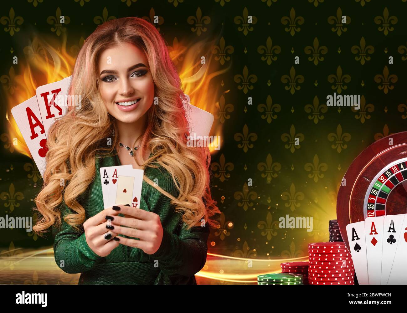 Smiling blonde girl in green stylish dress and jewelry. She is showing ...
