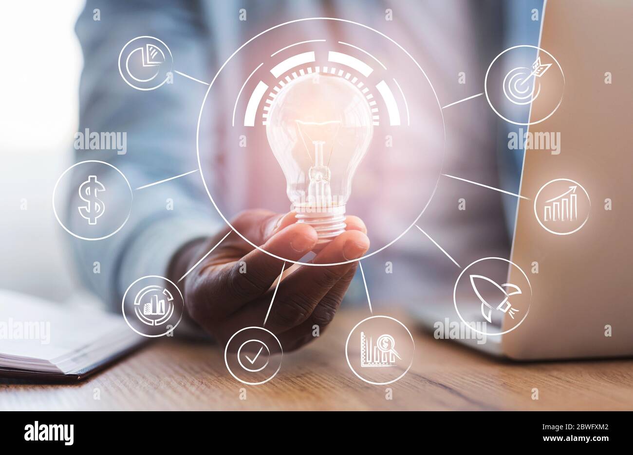 Businessman holding illuminated light bulb in hand, collage Stock Photo ... Businessman holding illuminated light bulb in hand, collage Stock Photo ...