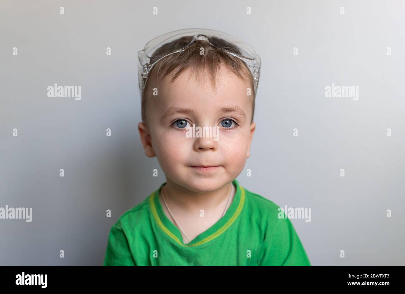 Close up the kid face wearing a protective glasses. Child face in ...