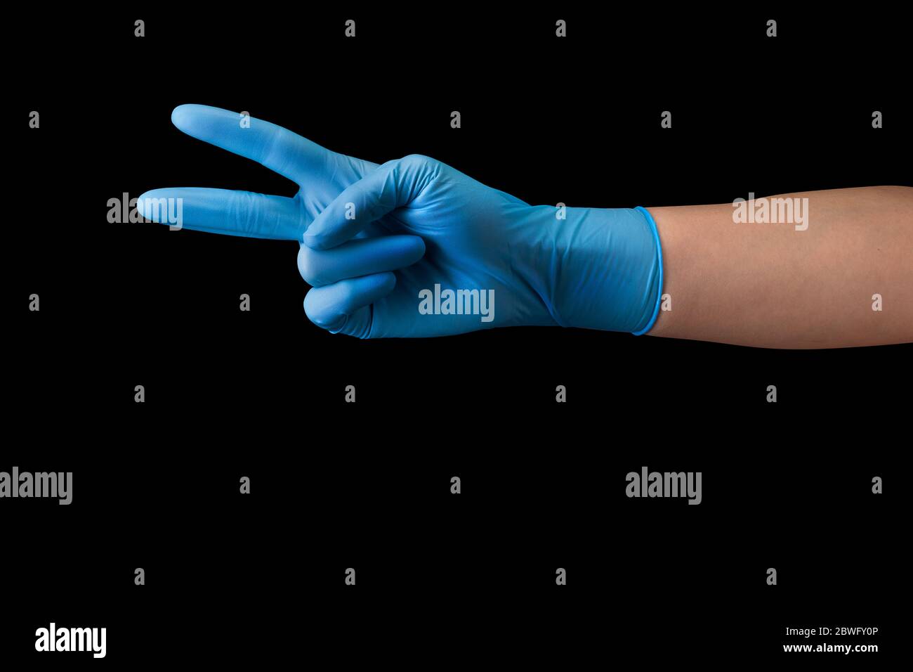 Doctor's hand in medical gloves showing two fingers up in peace symbol ...