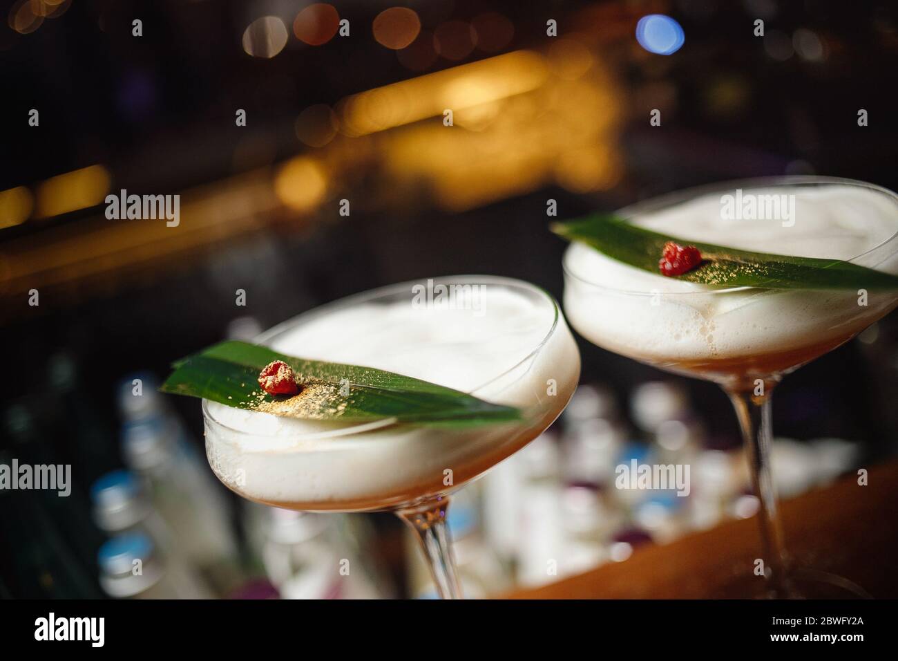 two tropical cocktails in glasses stand on the bar Stock Photo - Alamy
