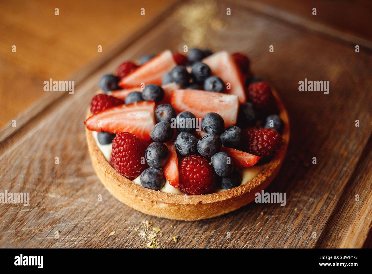 Strawberry tartlet on wooden hi-res stock photography and images - Alamy