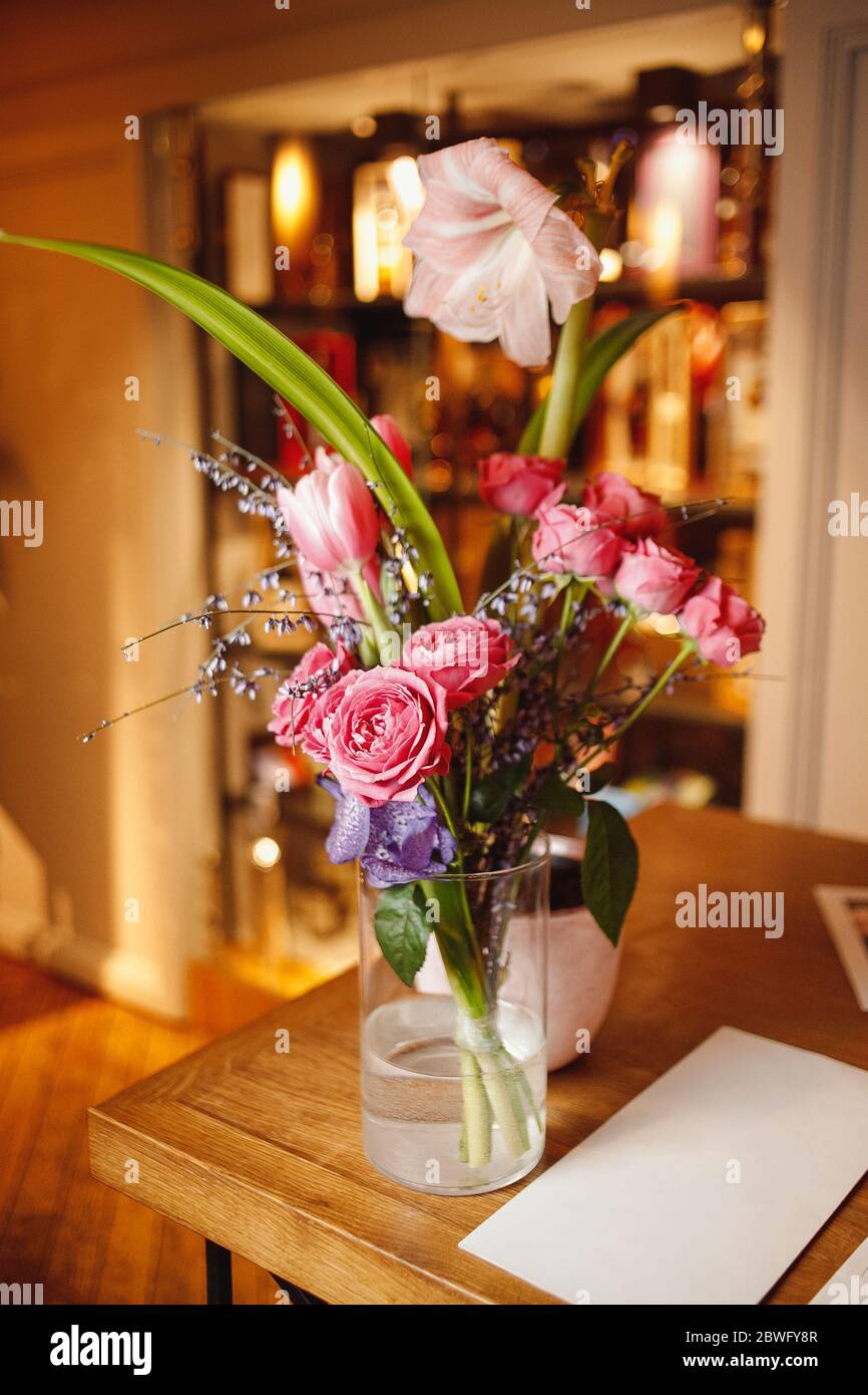 A vaz with flowers on the bar with glasses and wine Stock Photo - Alamy