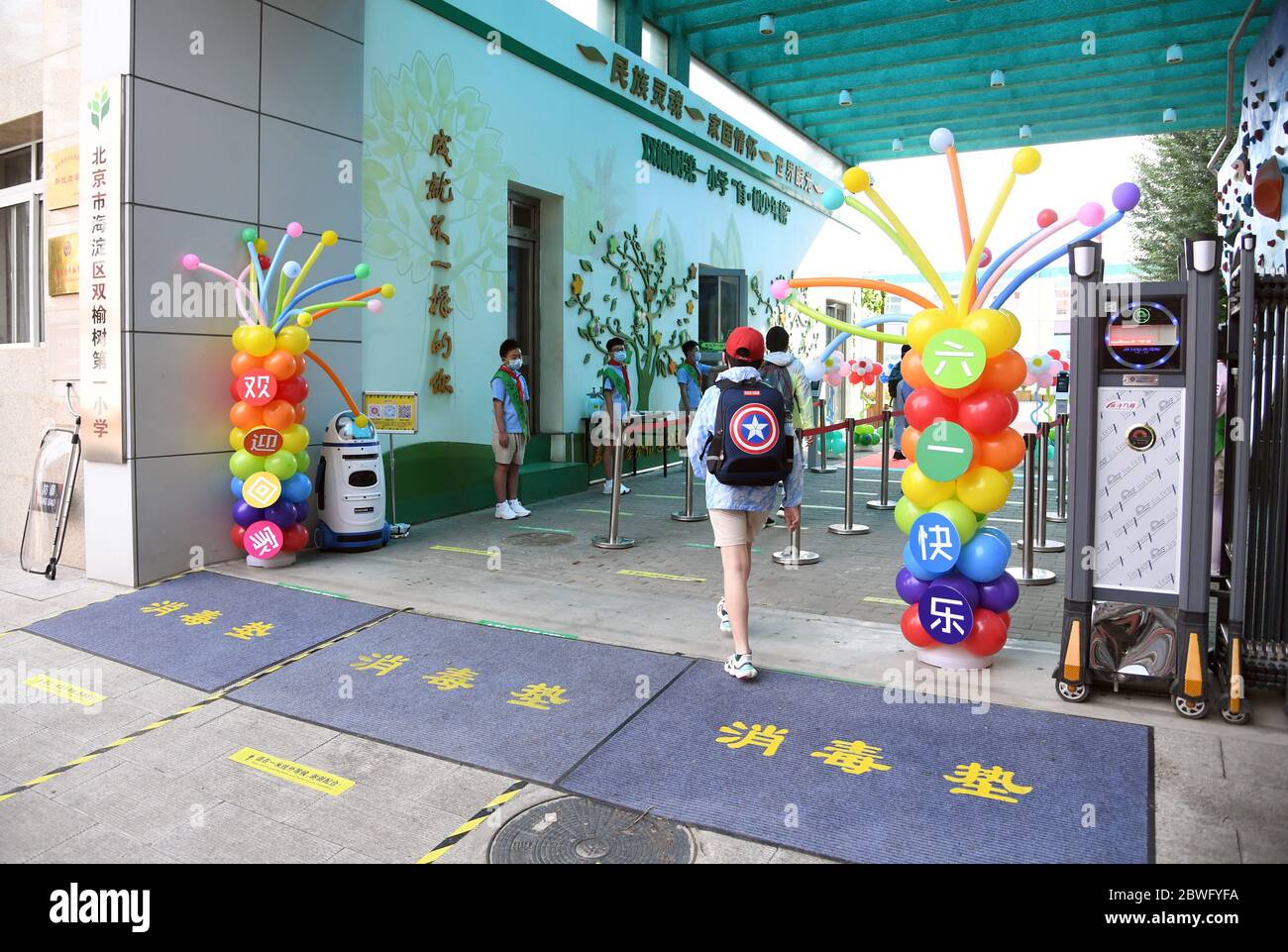 Beijing, China. 1st June, 2020. Students walk into the campus of ...