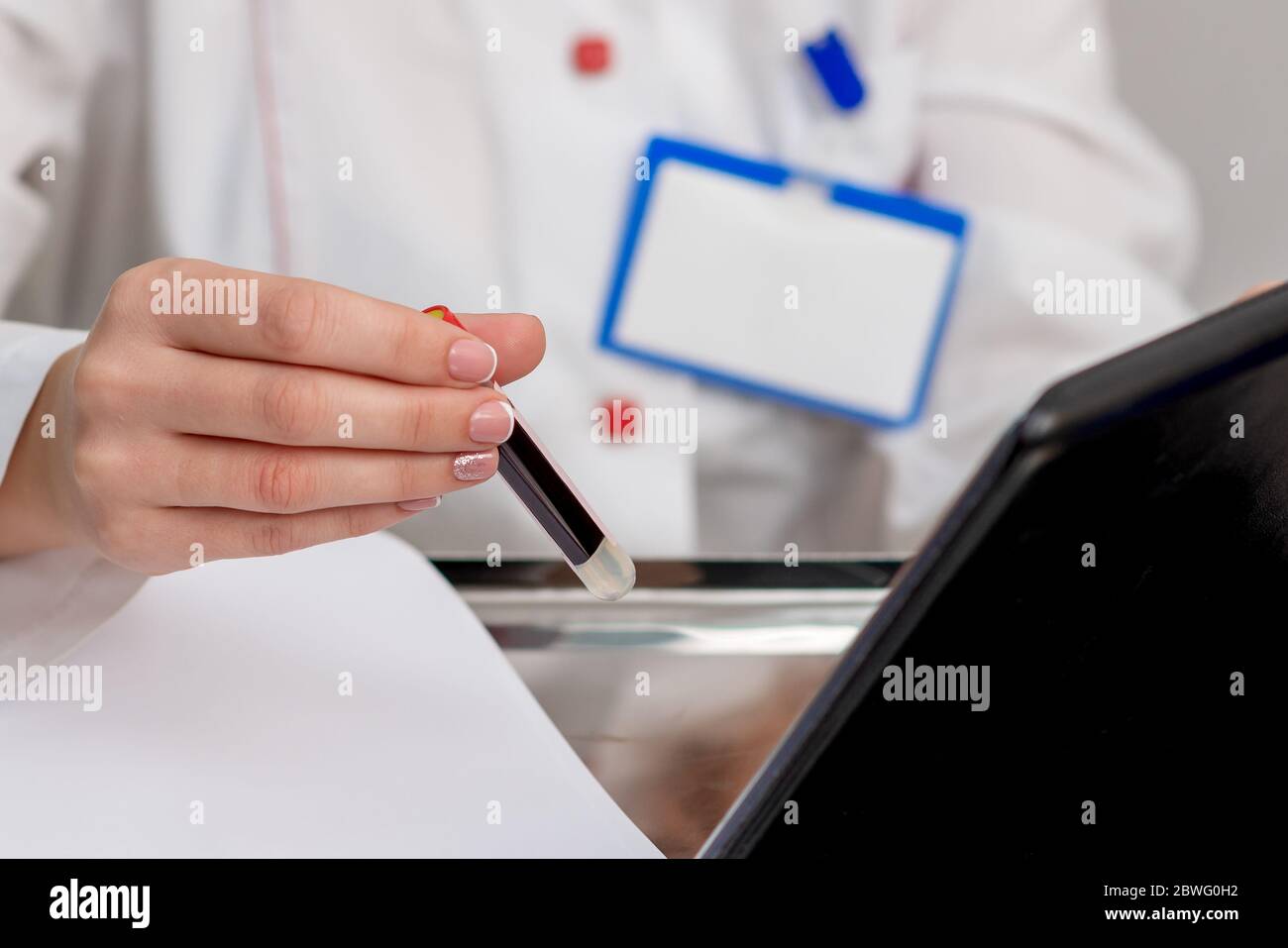 Hand of doctor holding test tube with blood writing diagnosis blood ...