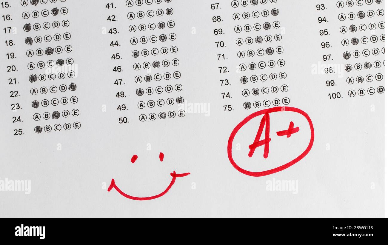 Final exam marked with A+ with red pencil Stock Photo - Alamy