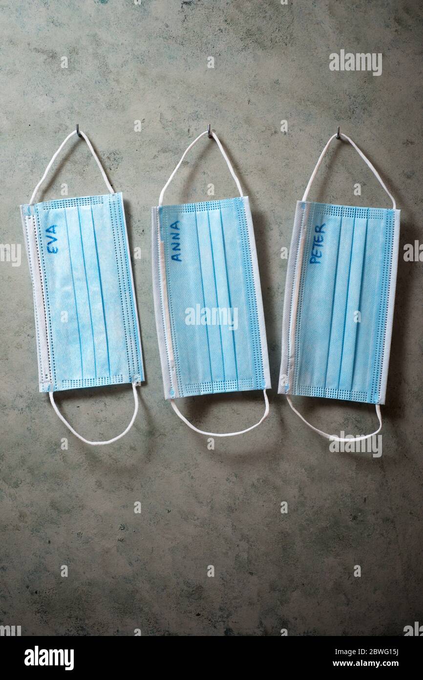 Surgical masks in a wall with the names of the users written Stock ...