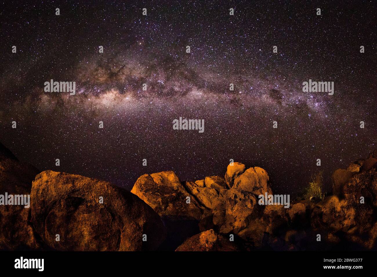 Rock formations under starry sky and Milky Way galaxy at night ...