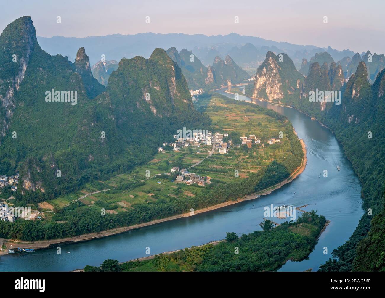 Shot of a Li river meandering through the beautiful green, lush and ...
