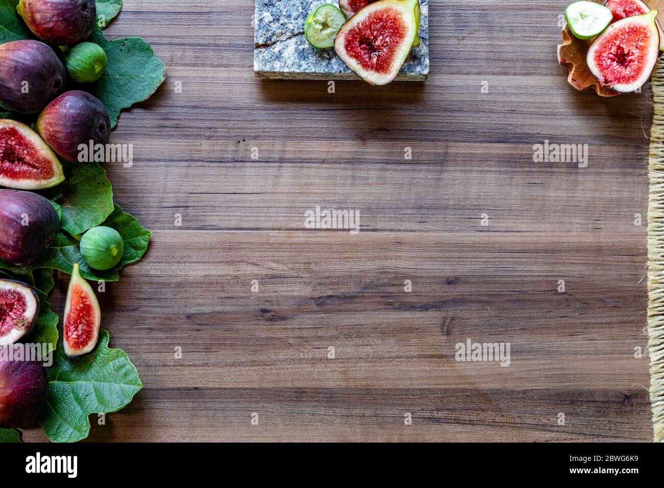Figs on rustic wooden background Stock Photo - Alamy