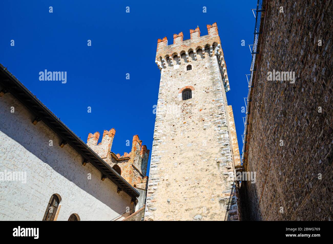 Sirmione, Italy, September 11, 2019: Tower and stone walls with merlons ...