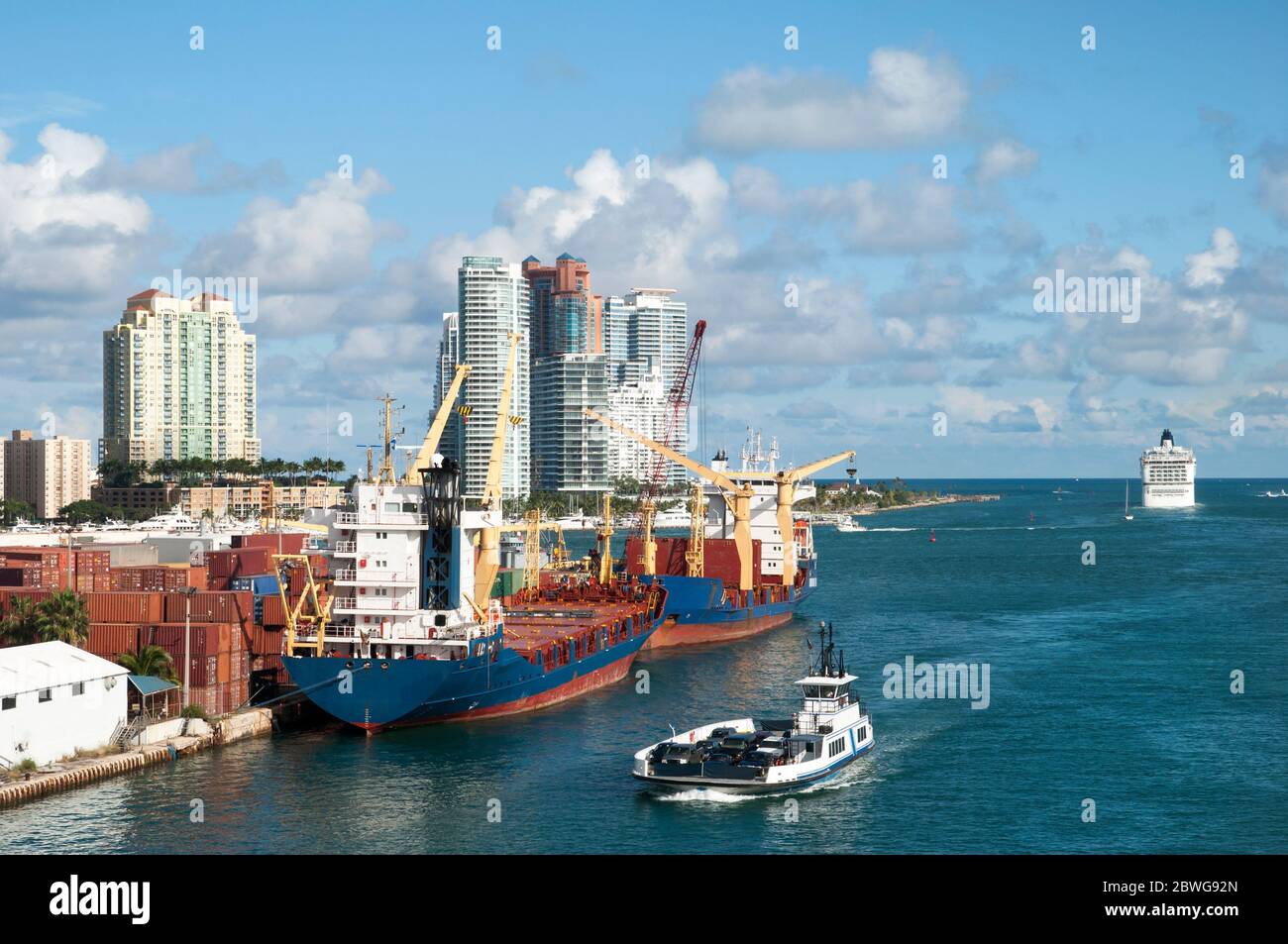 The view of ferry boat passing by cargo ships and Miami Beach skyline ...