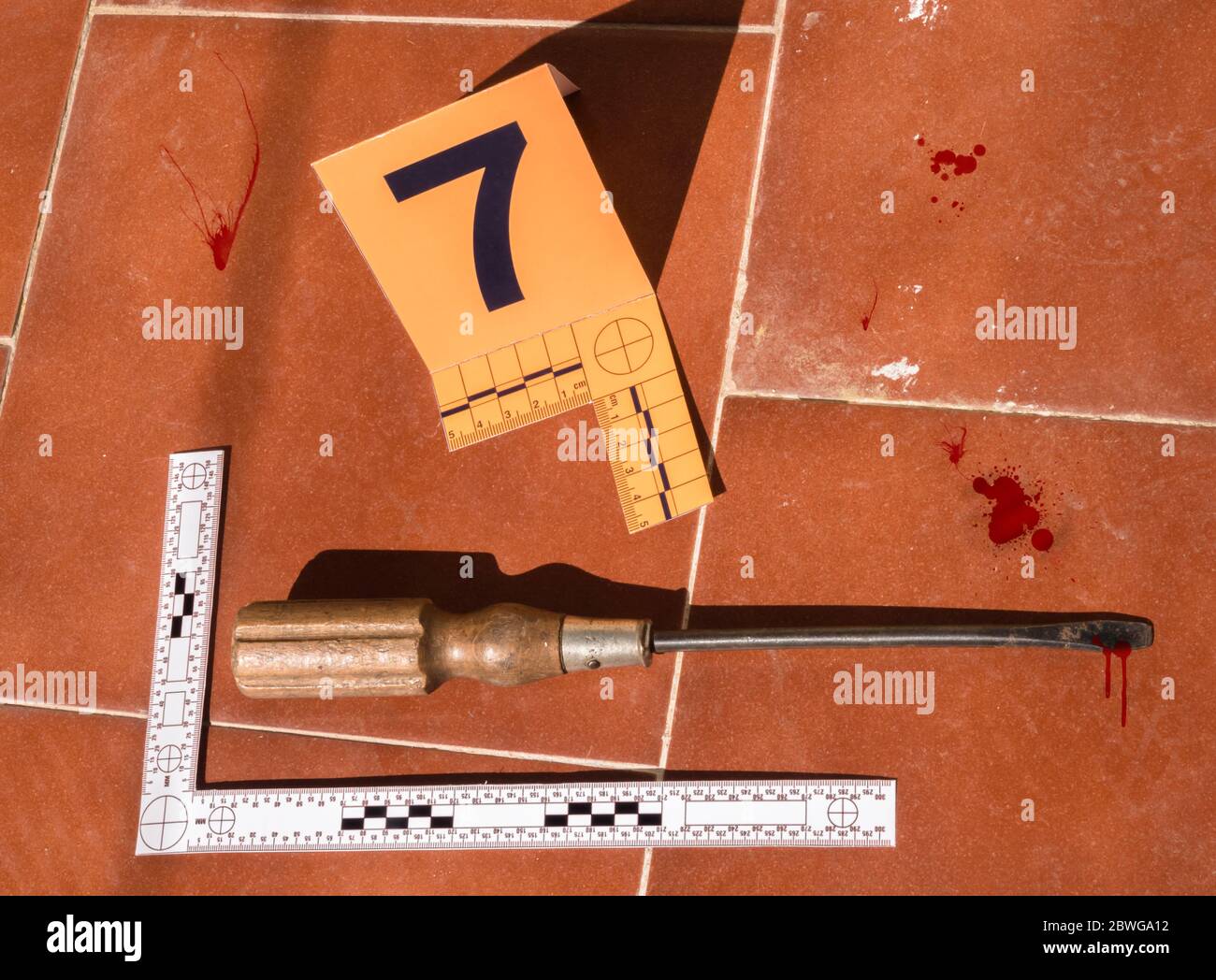 Screwdriver crime weapon on the ground, numbering in evidence ...