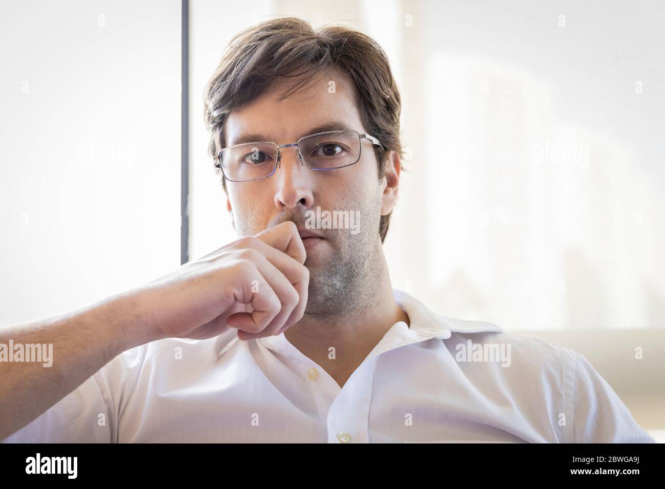 Man looking directly at the camera making a conference call, making ...