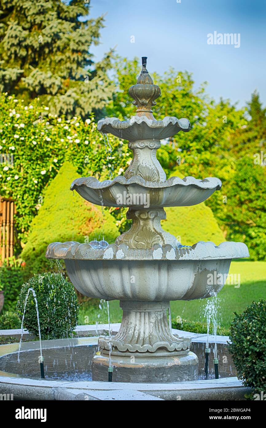 Splashing fountain in the summer garden Stock Photo - Alamy