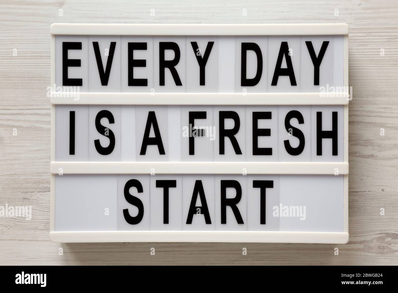 'Every day is a fresh start' words on a modern board on a white wooden ...