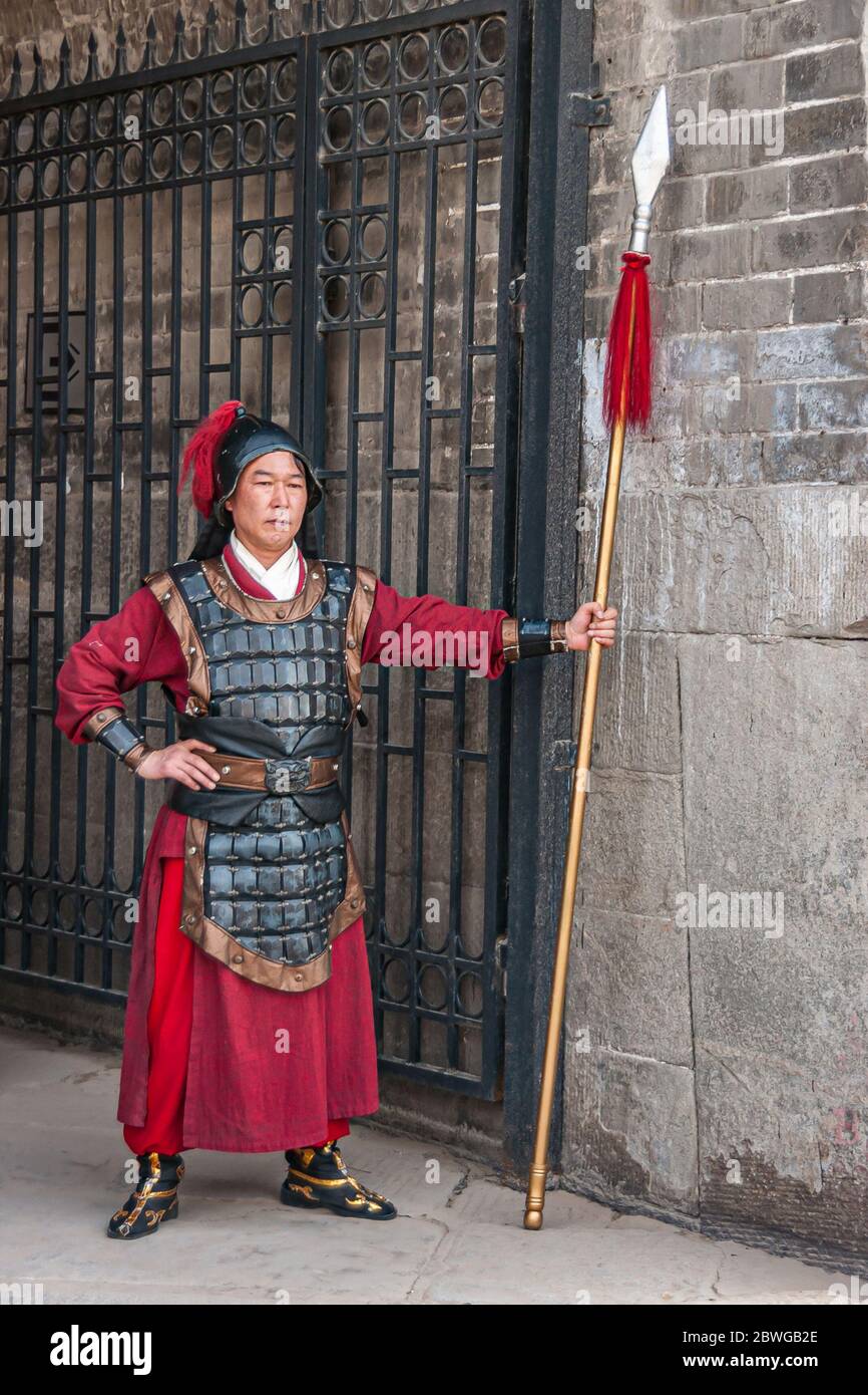 Xian, China - April 30, 2010: Closeup of male guard in traditional red ...
