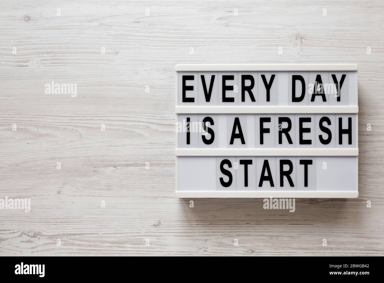 'Every day is a fresh start' words on a lightbox on a white wooden ...