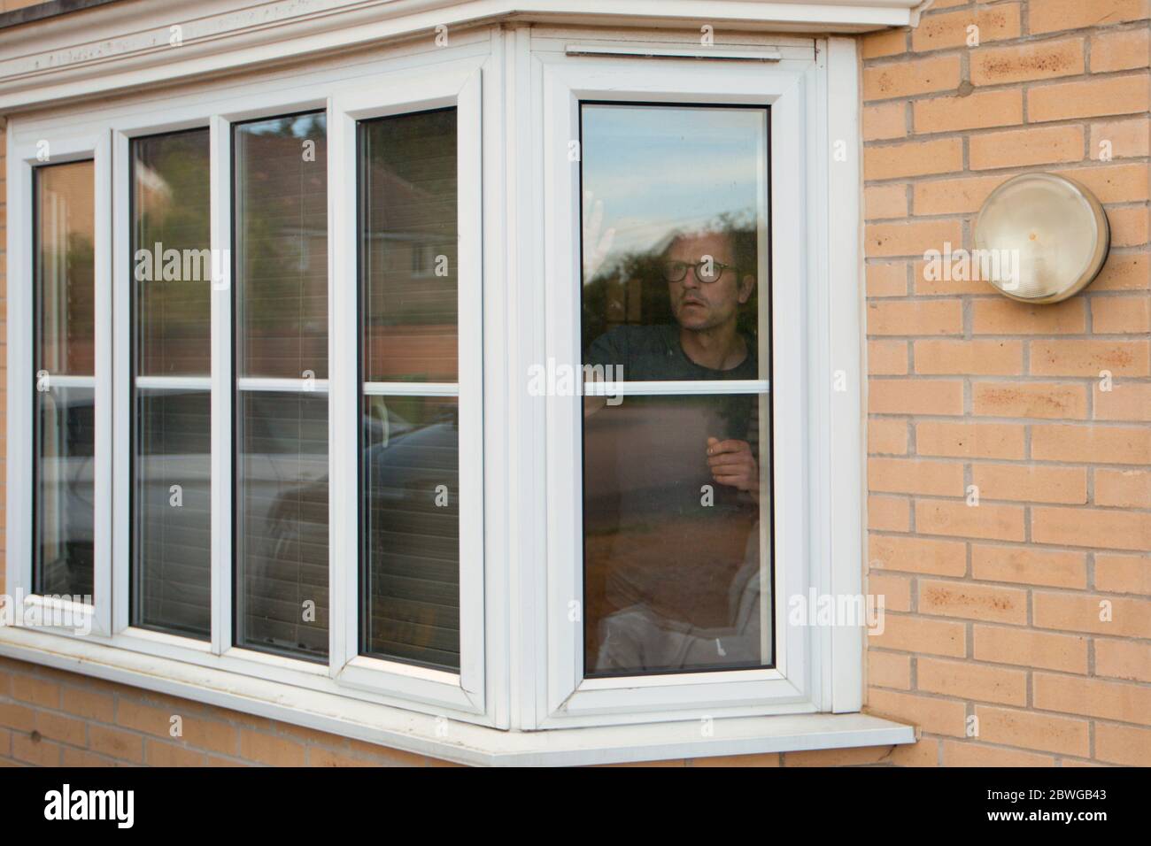 Depressed man looking out of window hi-res stock photography and images ...