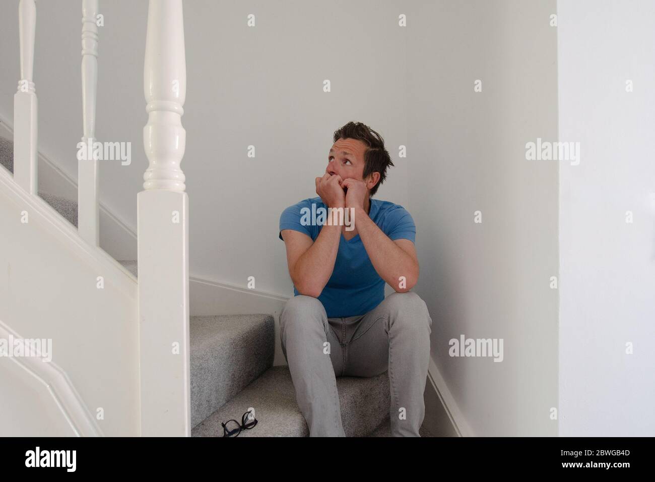Man struggling with depression sitting on stairs Stock Photo - Alamy