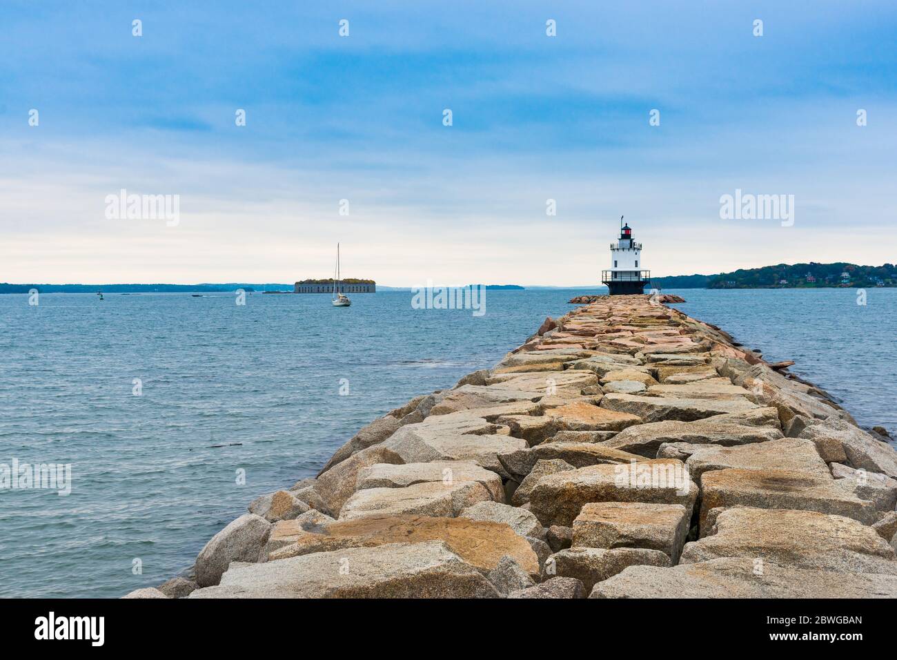 Portland Maine, Bug Lighthouse in bay with rock path and breawater ...
