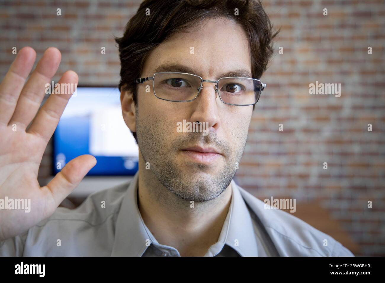 Man looking directly at the camera making a conference call, making ...