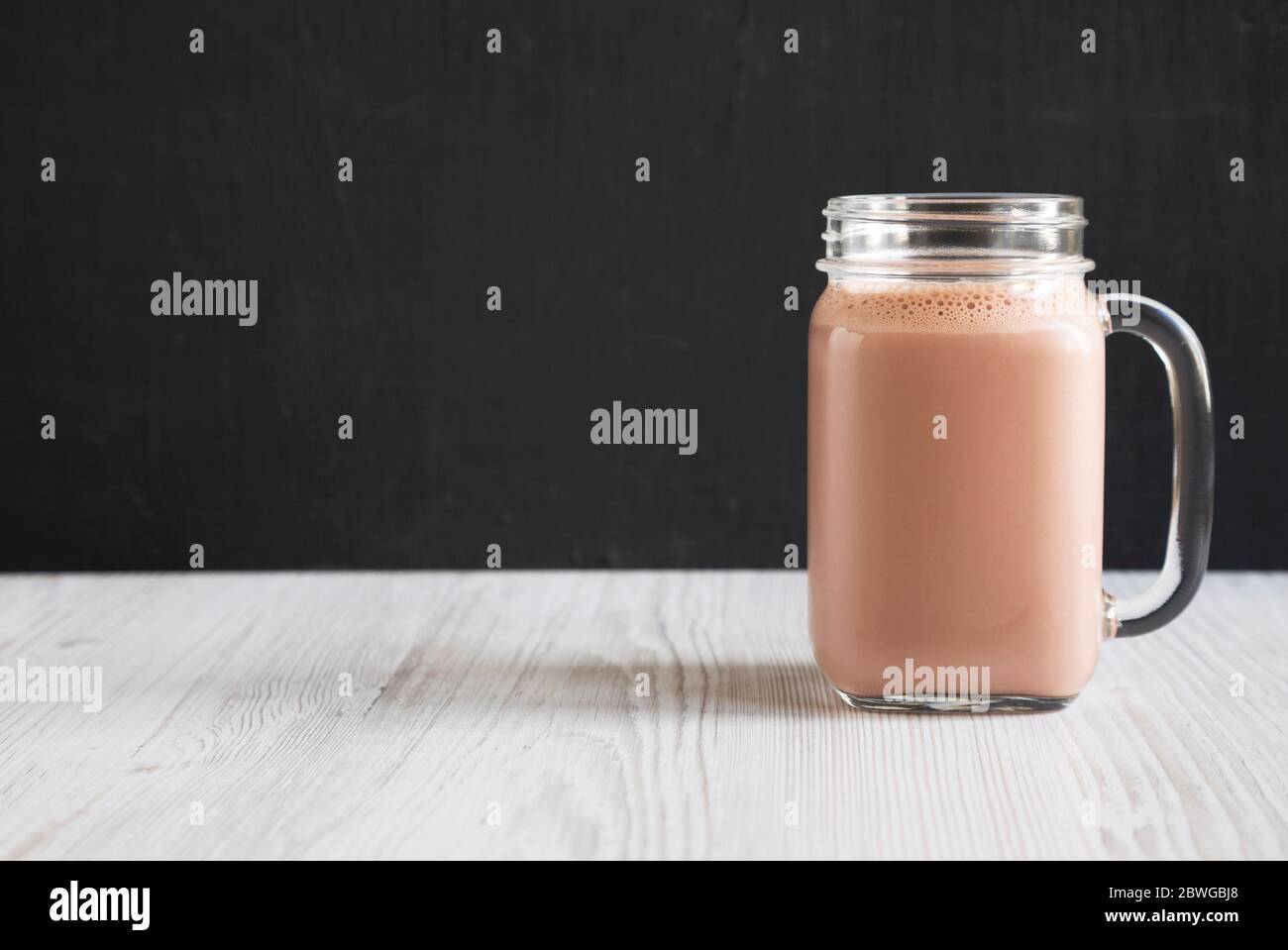 Homemade New England Chocolate Milkshake in a Glass Jar Mug, side view ...