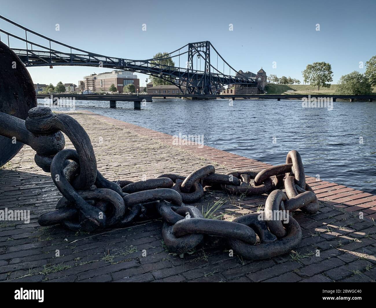 an old thick anchor chain lies on the harbour wall Stock Photo - Alamy