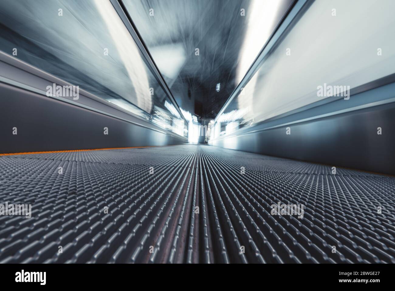 Long exposure shooting from the bottom of a moving walkway in an ...