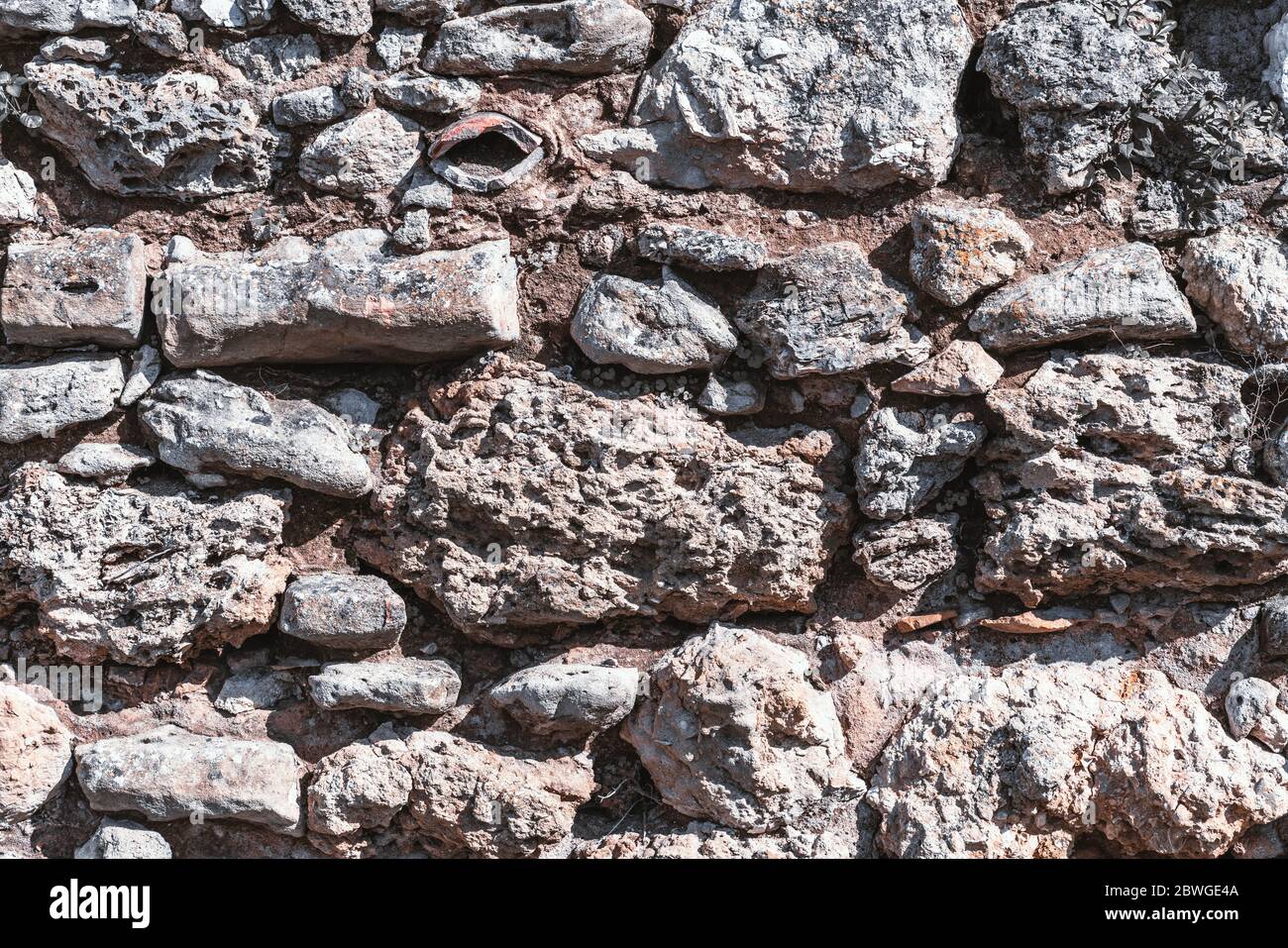 The texture of the wall of stones of different sizes, limestone, and ...