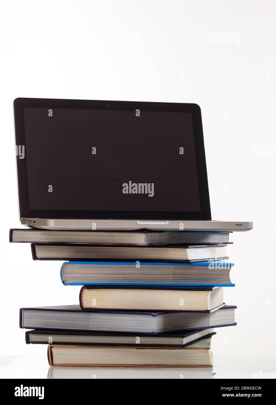 E learning concept. Books stack and an open computer laptop with black ...