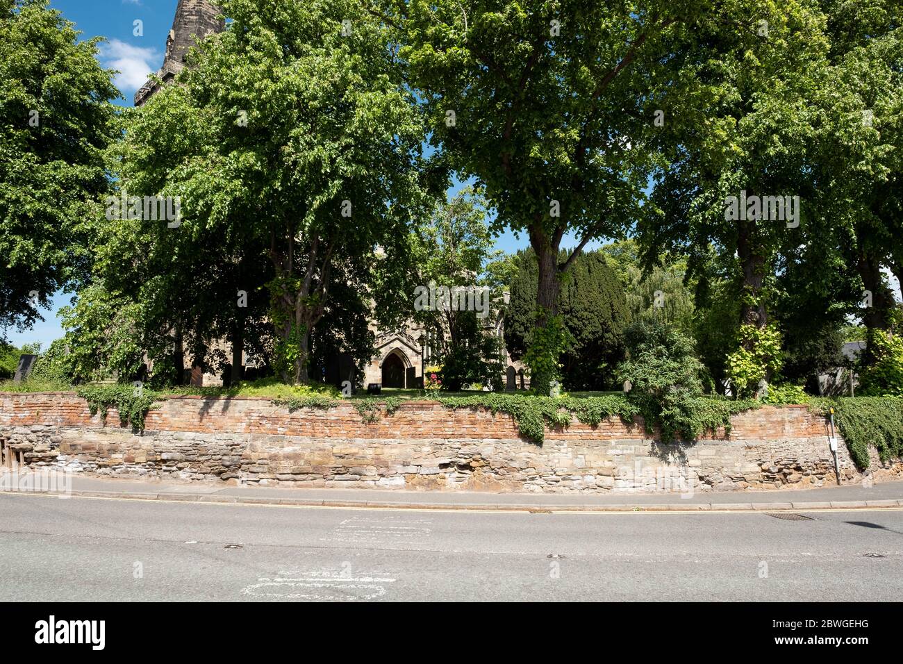Church yard hidden by trees Stock Photo - Alamy