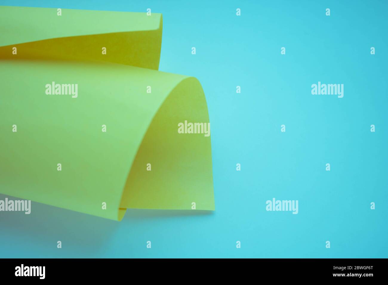 A roll of yellow paper isolated on a blue background.space for text ...