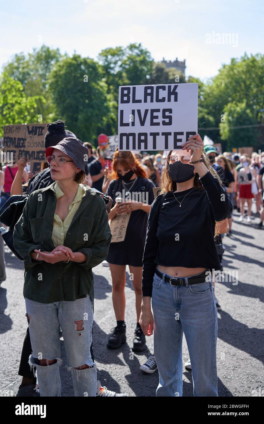 Portrait of protesters holding placards outside the US Embassy during a ...