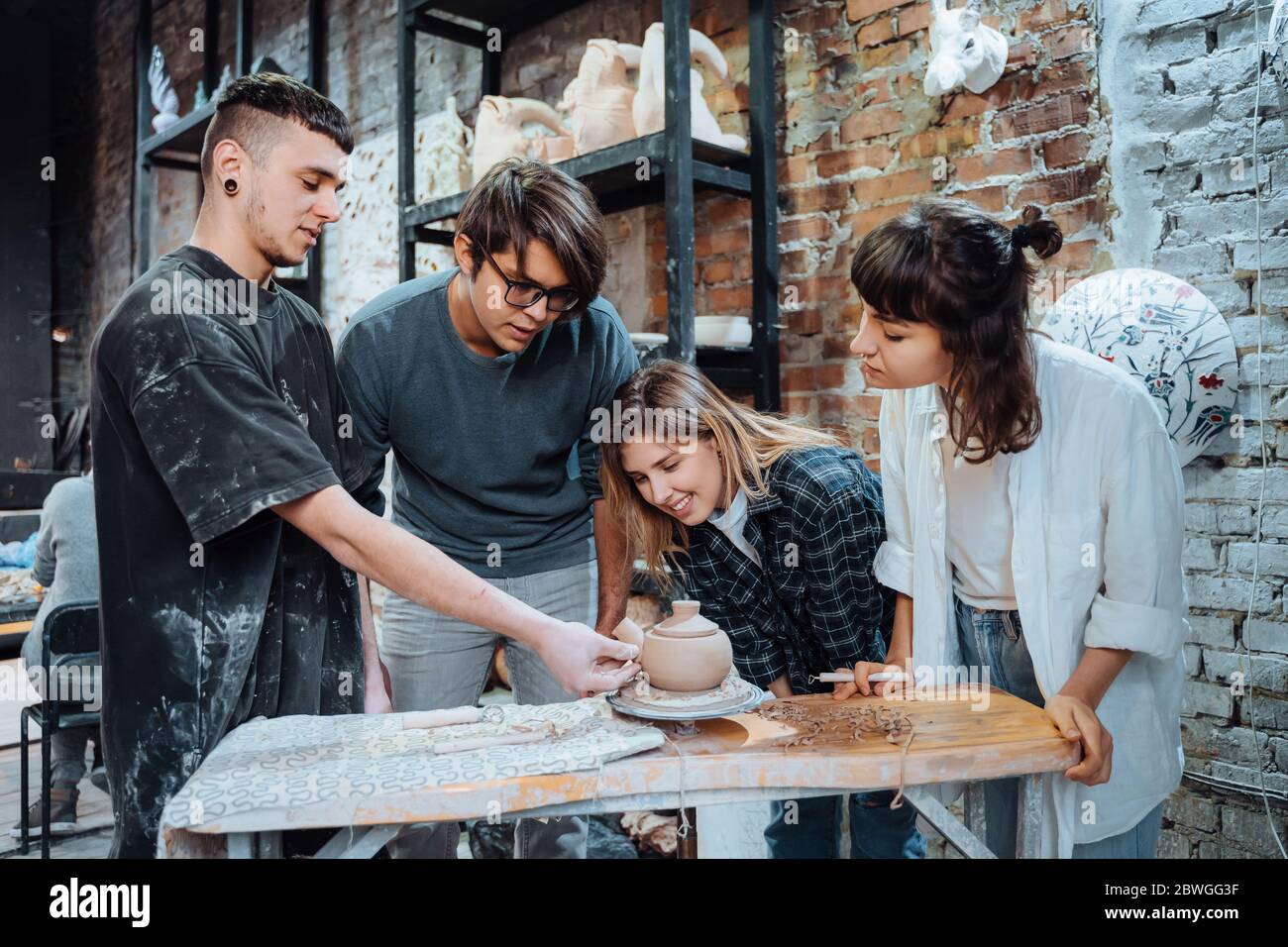 Making a handmade clay pot. Pottery lesson with master Stock Photo - Alamy