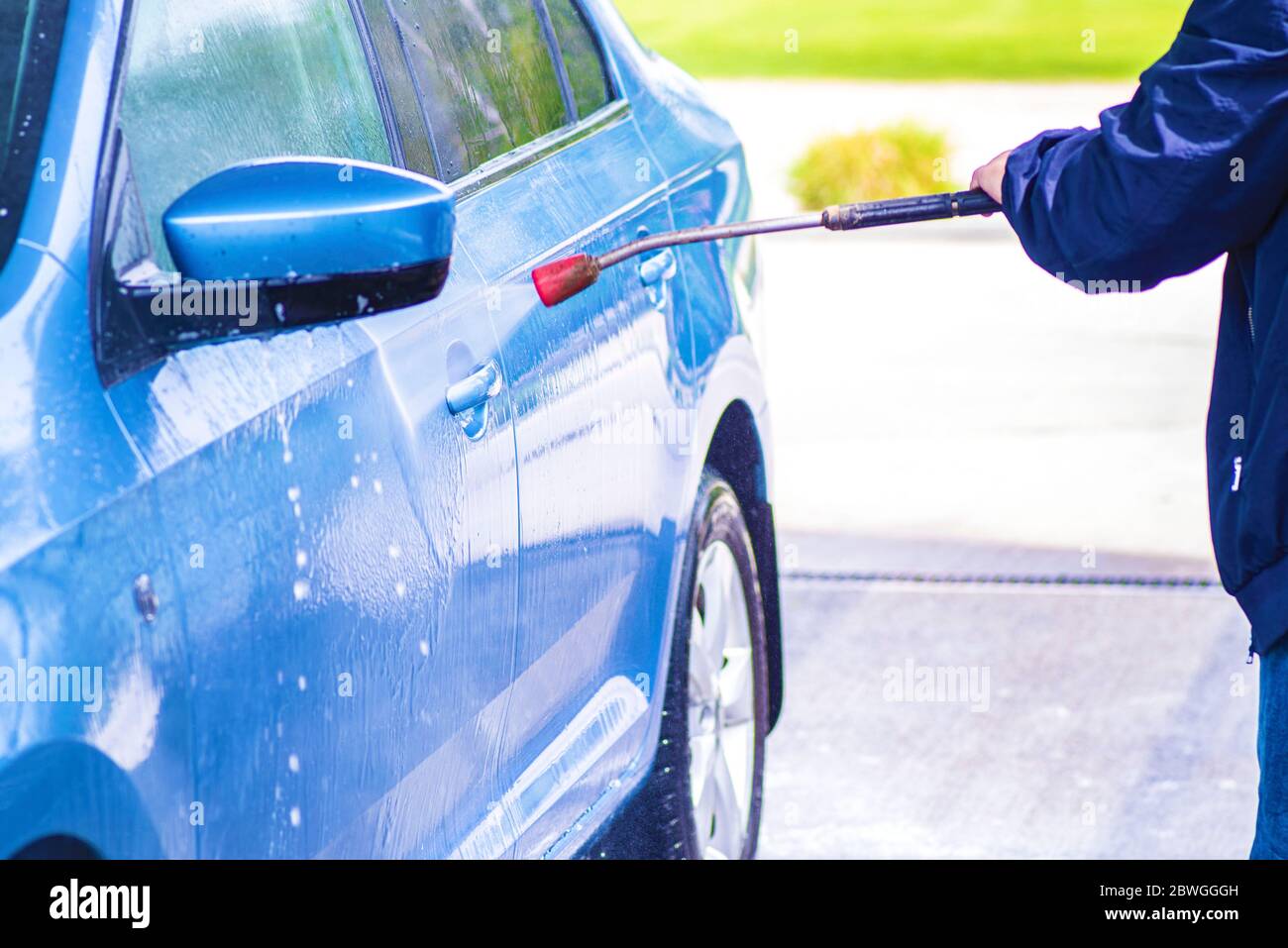 Cleaning Car Using High Pressure Water.Manual car wash with pressurized ...