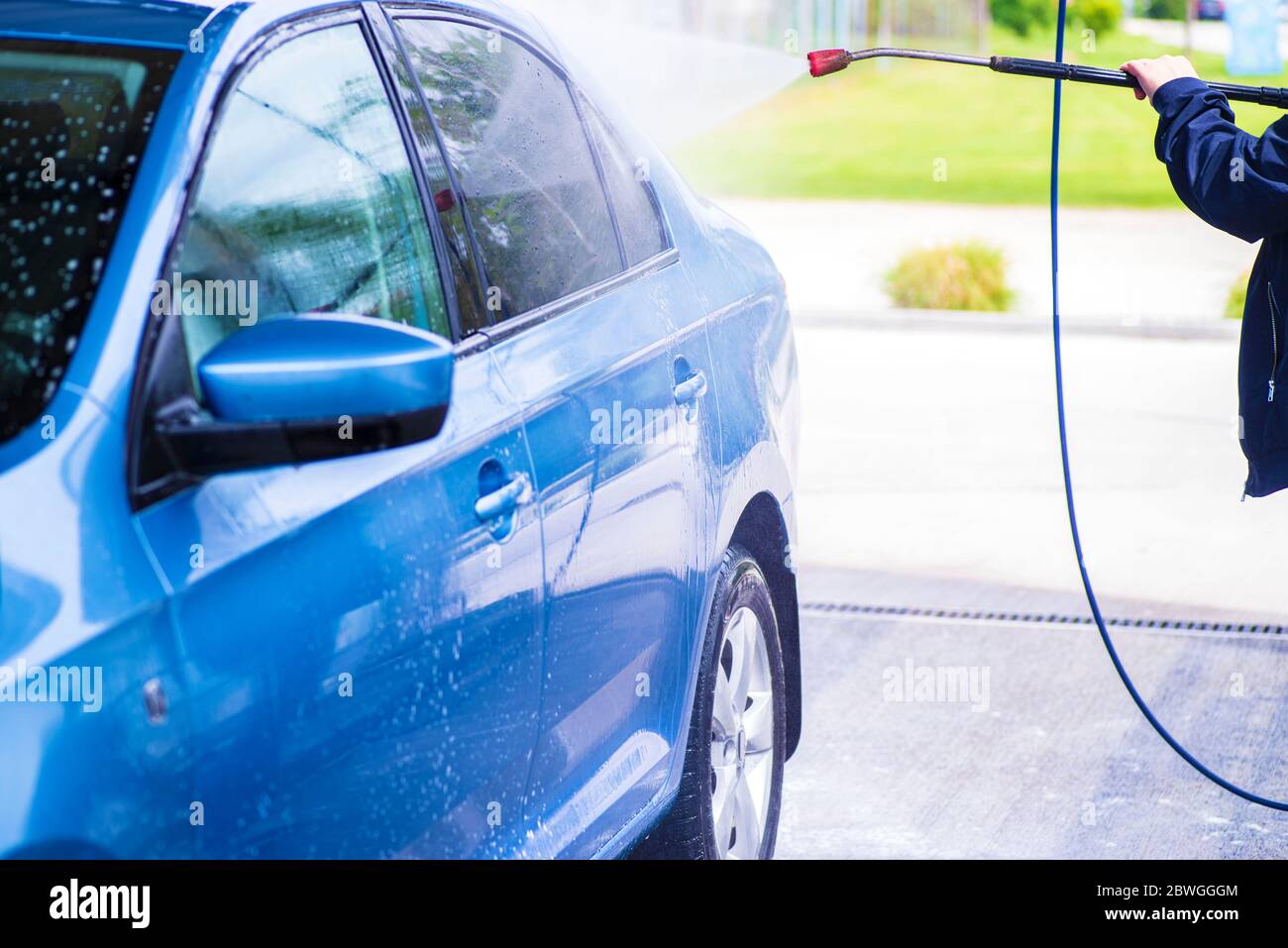 Cleaning Car Using High Pressure Water.Manual car wash with pressurized ...