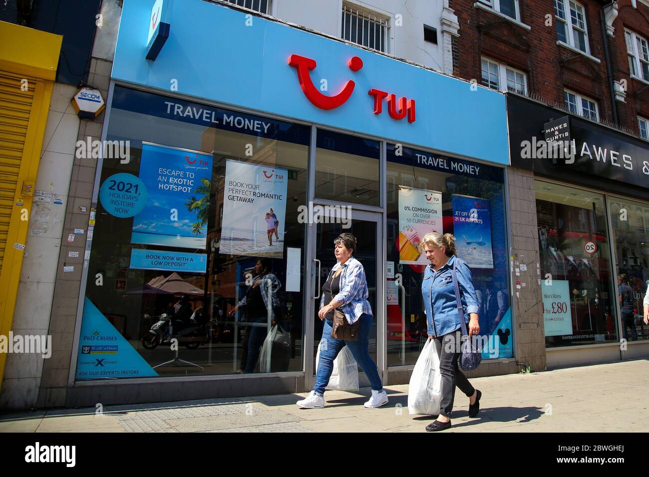 Women walk past a branch of TUi travel agency in north London Stock ...