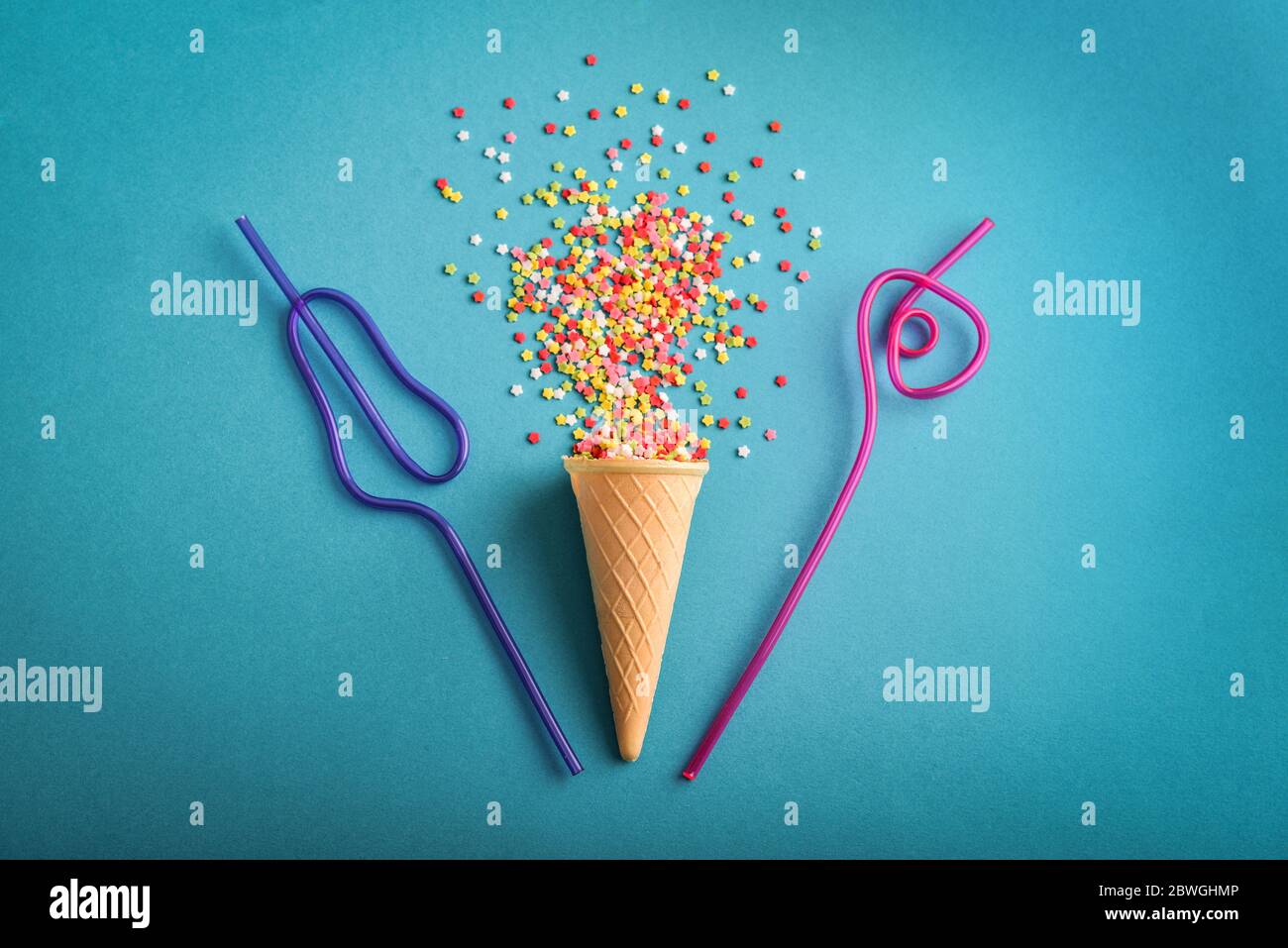 Celebration concept. Ice cream cone with colorful stars confetti on a ...