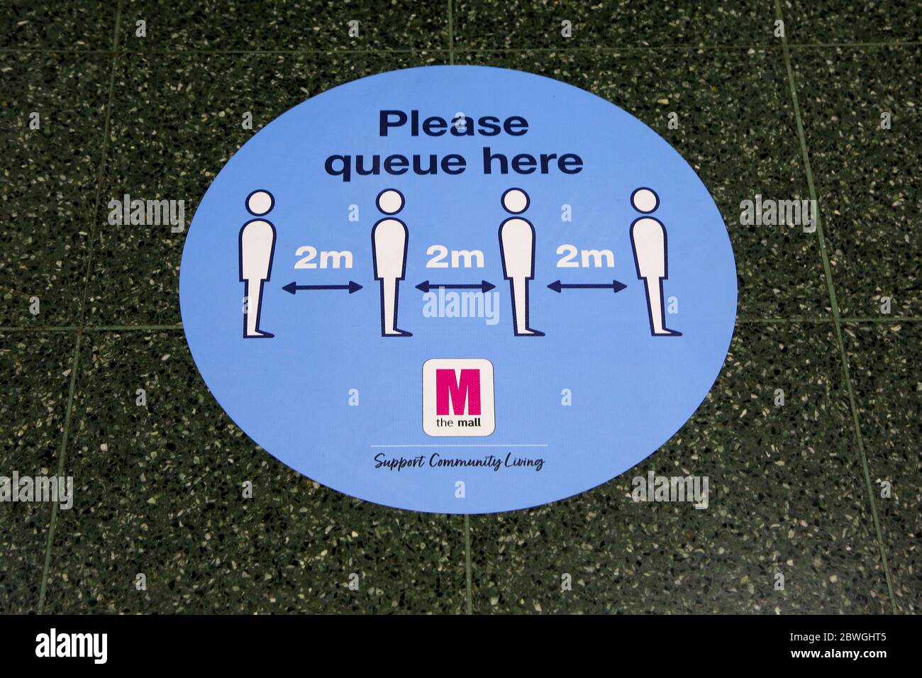 Please queue here sticker seen on the floor at a shopping mall in north ... Please queue here sticker seen on the floor at a shopping mall in north ...