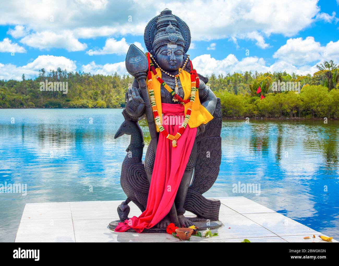 Hindu statue with landscape of Grand Bassin lake - a sacred crater lake ...